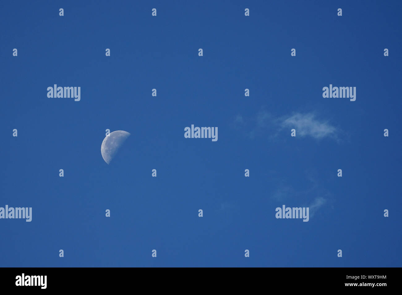 HALF MOON AND CLOUDS IN THE DAYTIME Stock Photo - Alamy