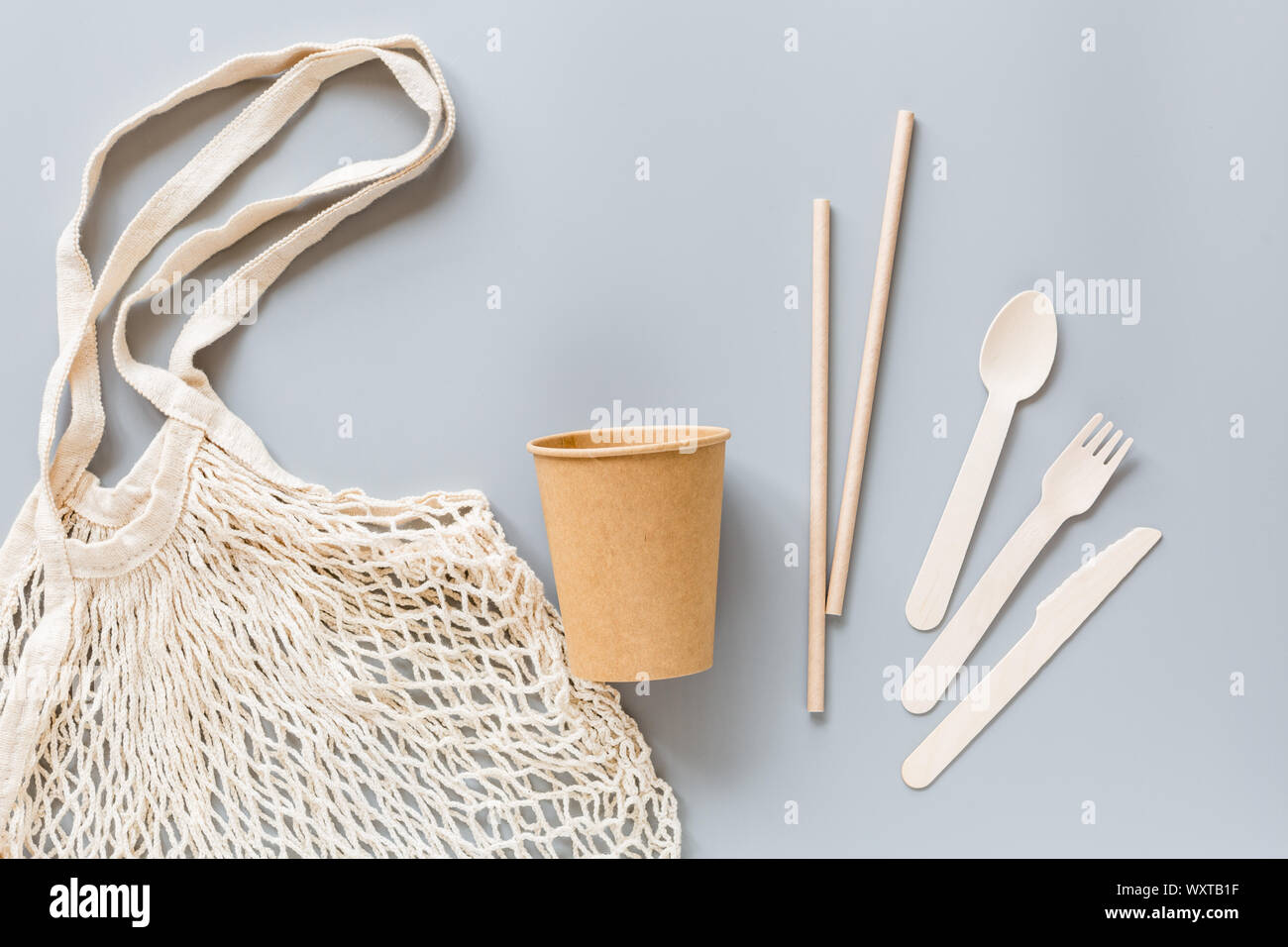 eco natural paper cups, straws, bag flat lay on gray background ...