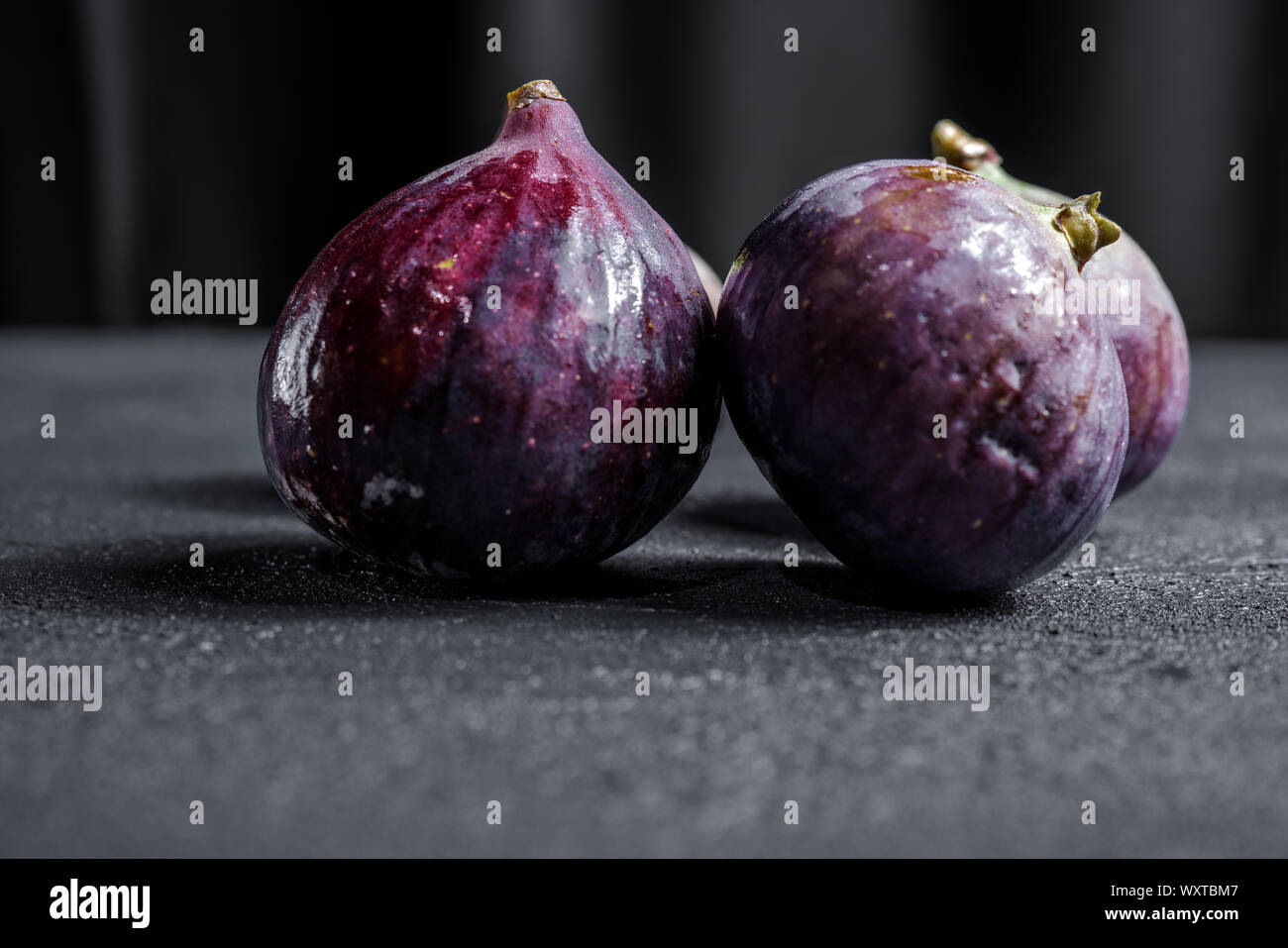 fresh figs close-up photo on black background. dark moody photo Stock ...