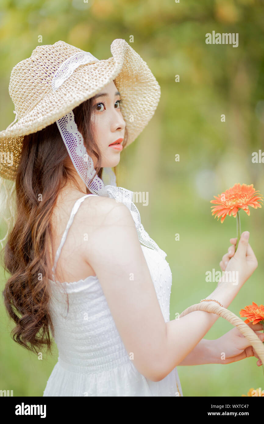 Beautiful girl in white dress, beautiful face in the weather to fall ...
