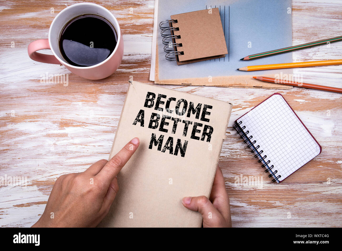Become a Better Man. Hands holding book Stock Photo - Alamy