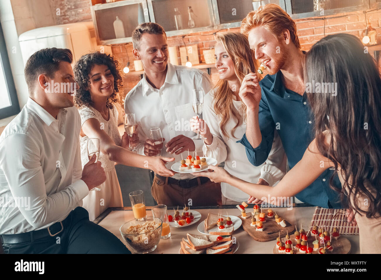 Group happy friends eating sandwiches hi-res stock photography and ...