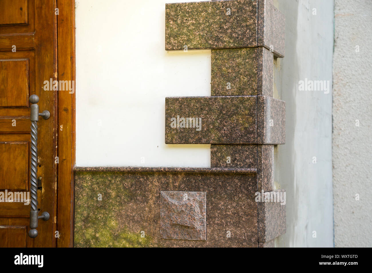 Close up view of part of a building facade with the surface of granite ...