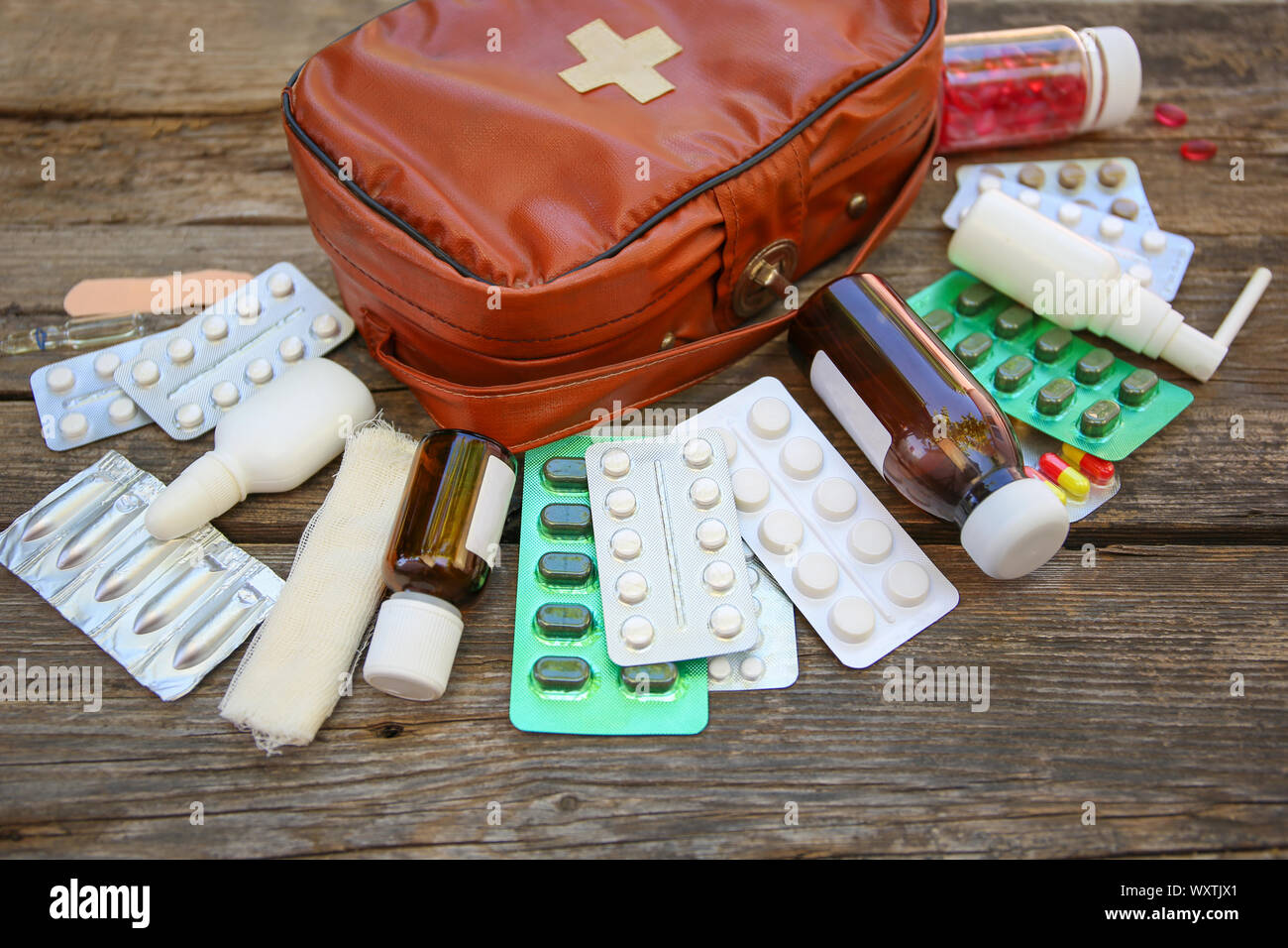 First aid kit on old wooden background Stock Photo - Alamy