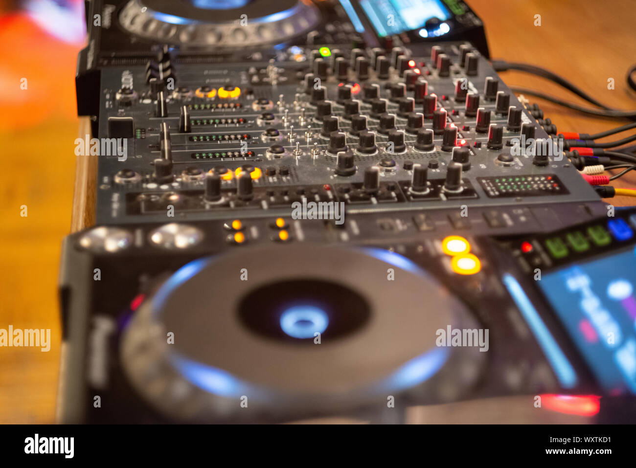 DJ CD player and mixer. DJ Spinning, Mixing, and Scratching in a Night ...
