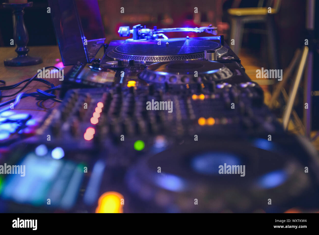 DJ CD player and mixer. DJ Spinning, Mixing, and Scratching in a Night ...