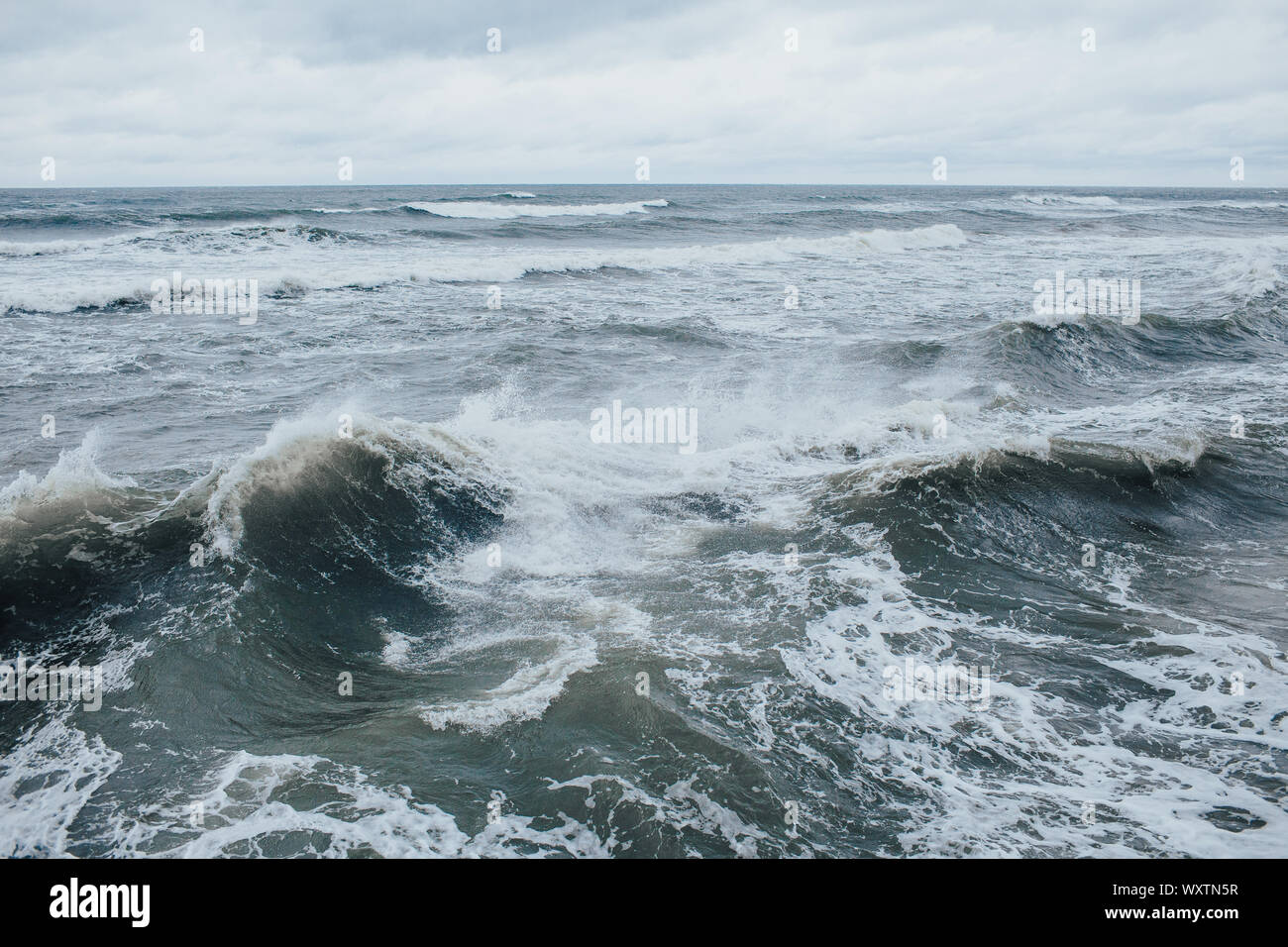 Waves Breaking and Spraying at High Seas and Strong Winds Stock Photo ...
