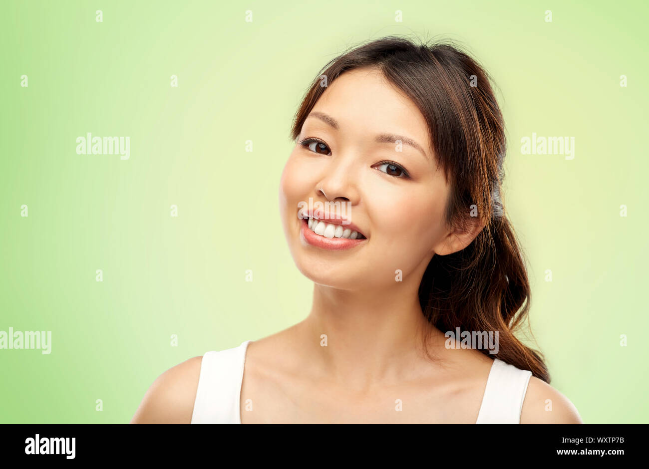 beauty and people concept - face of happy smiling young asian woman ...