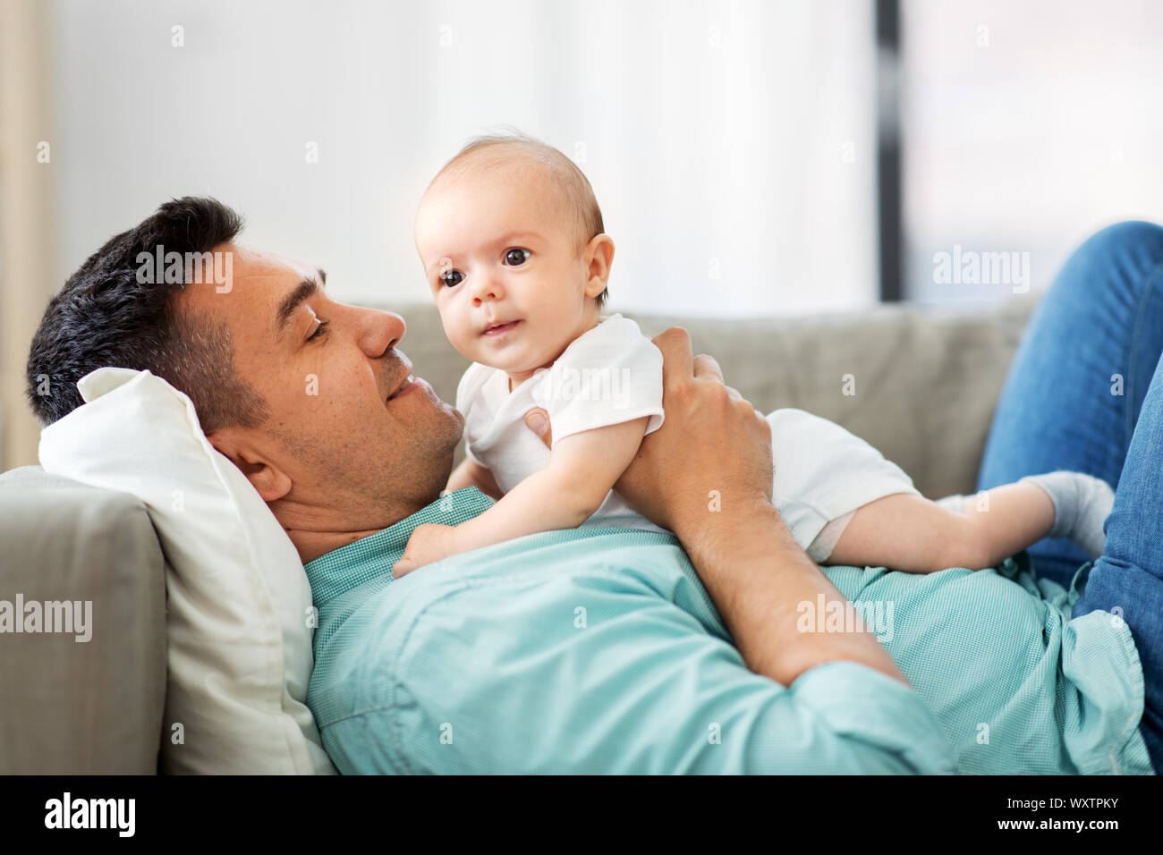 family, parenthood and fatherhood concept - happy smiling middle aged ...