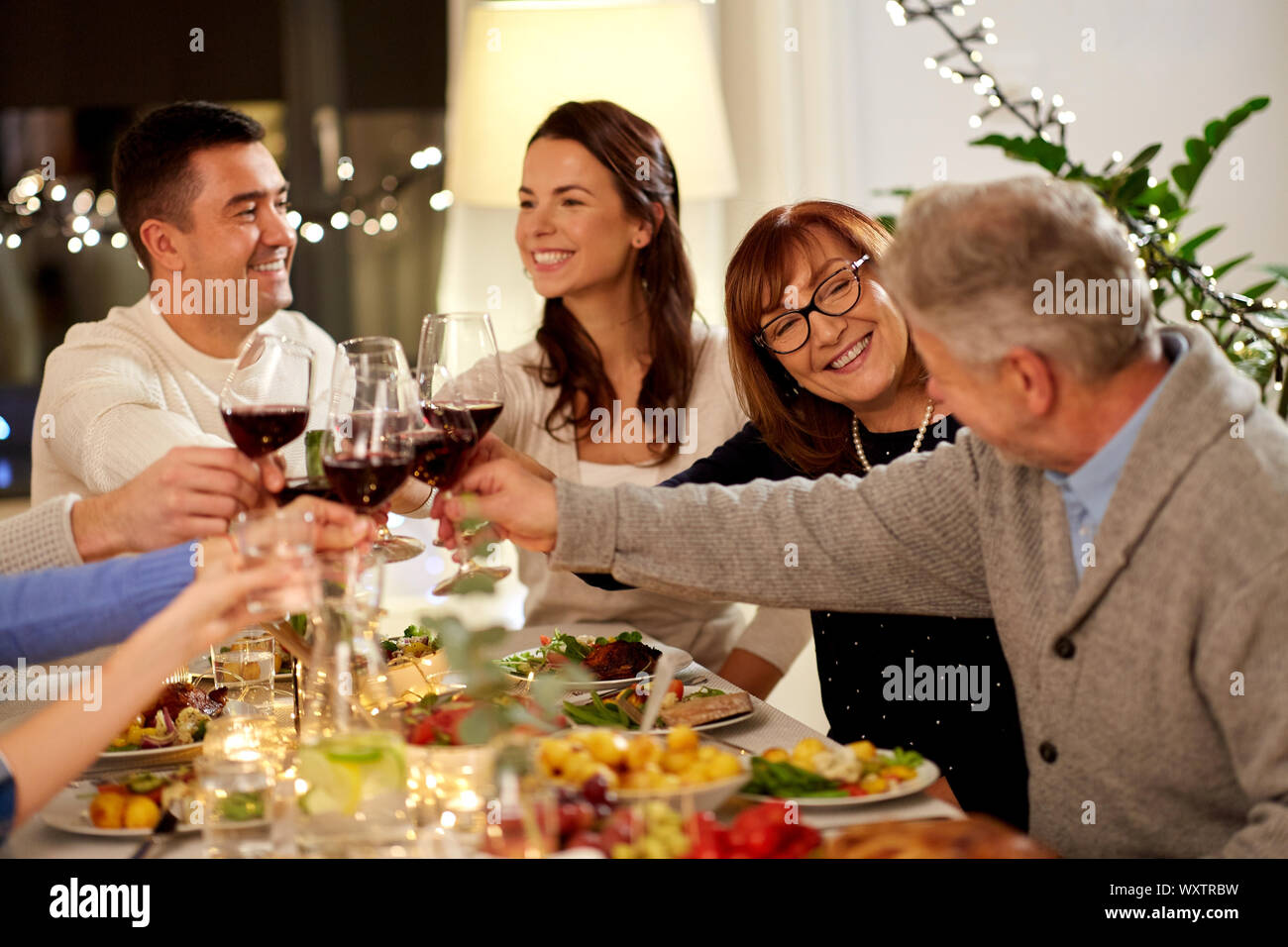 celebration, holidays and people concept - happy family having dinner ...