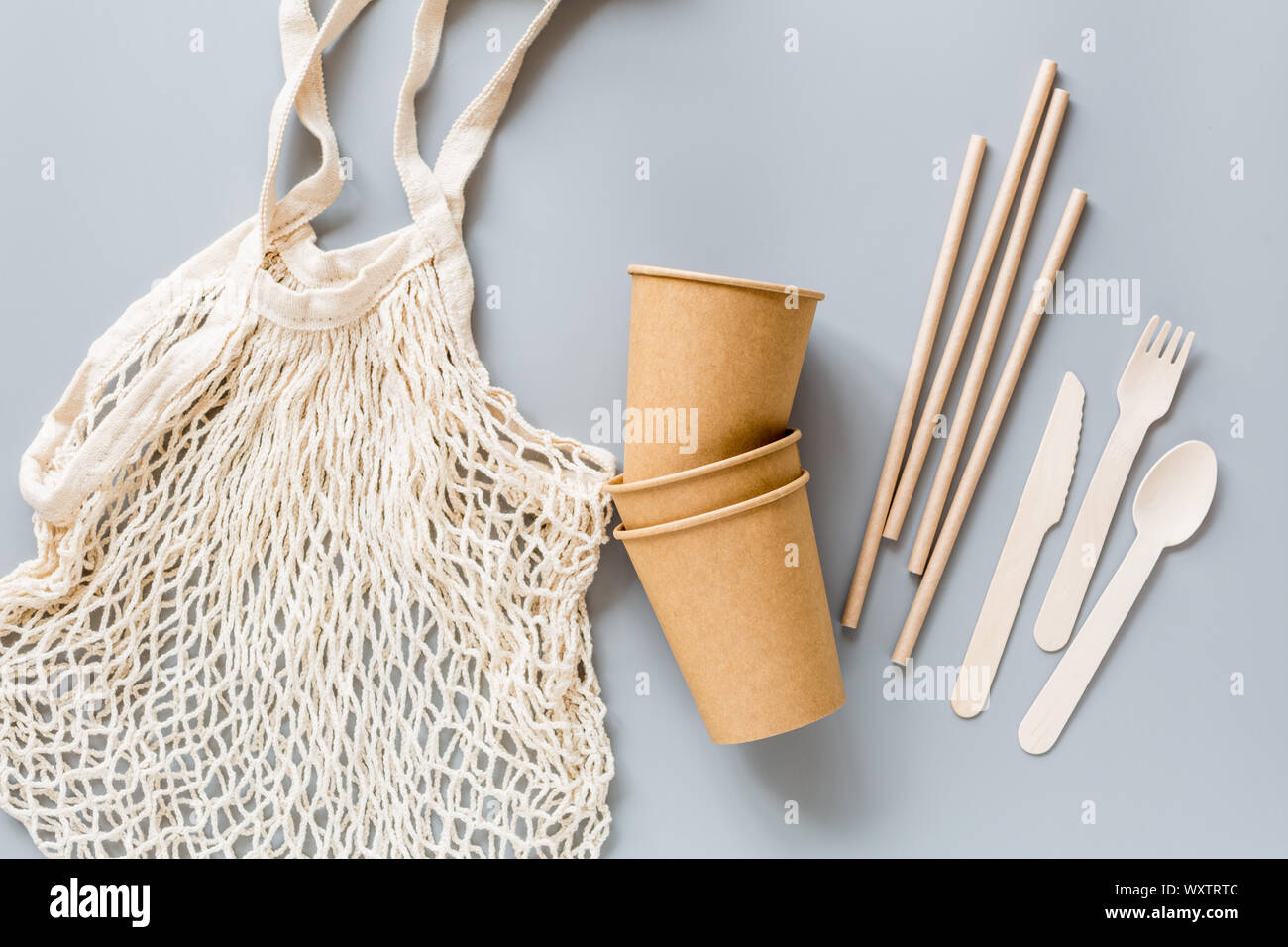 eco natural paper cups, straws, bag flat lay on gray background ...