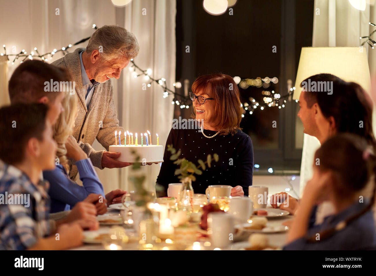 celebration and people concept - happy family with cake having birthday ...