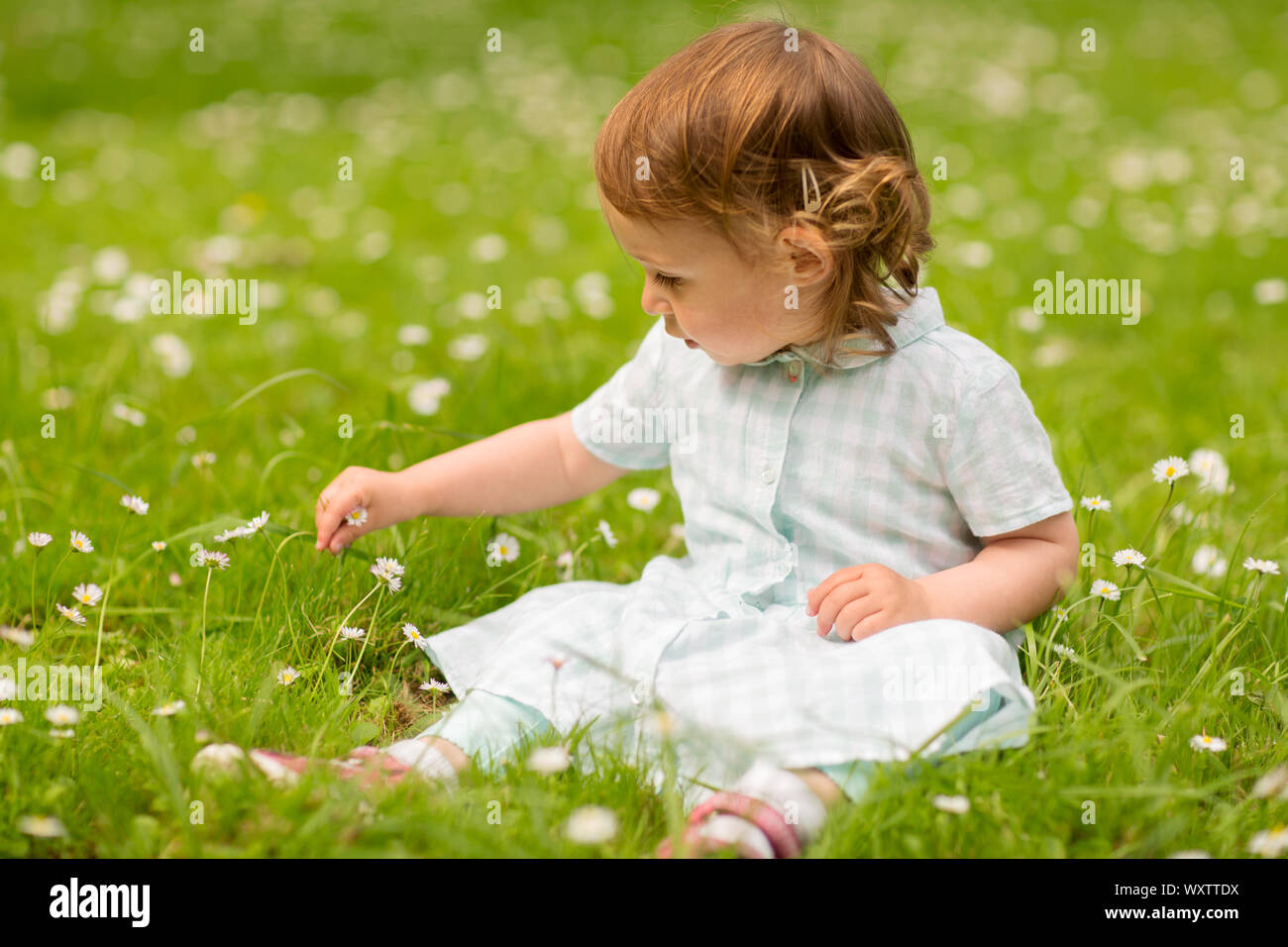 childhood, leisure and people concept - happy little baby girl playing ...