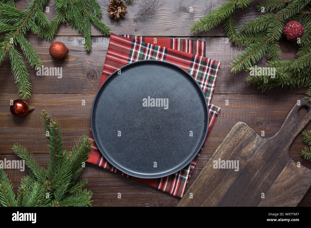 Christmas food border with black plate, evegreen branches, and red ...