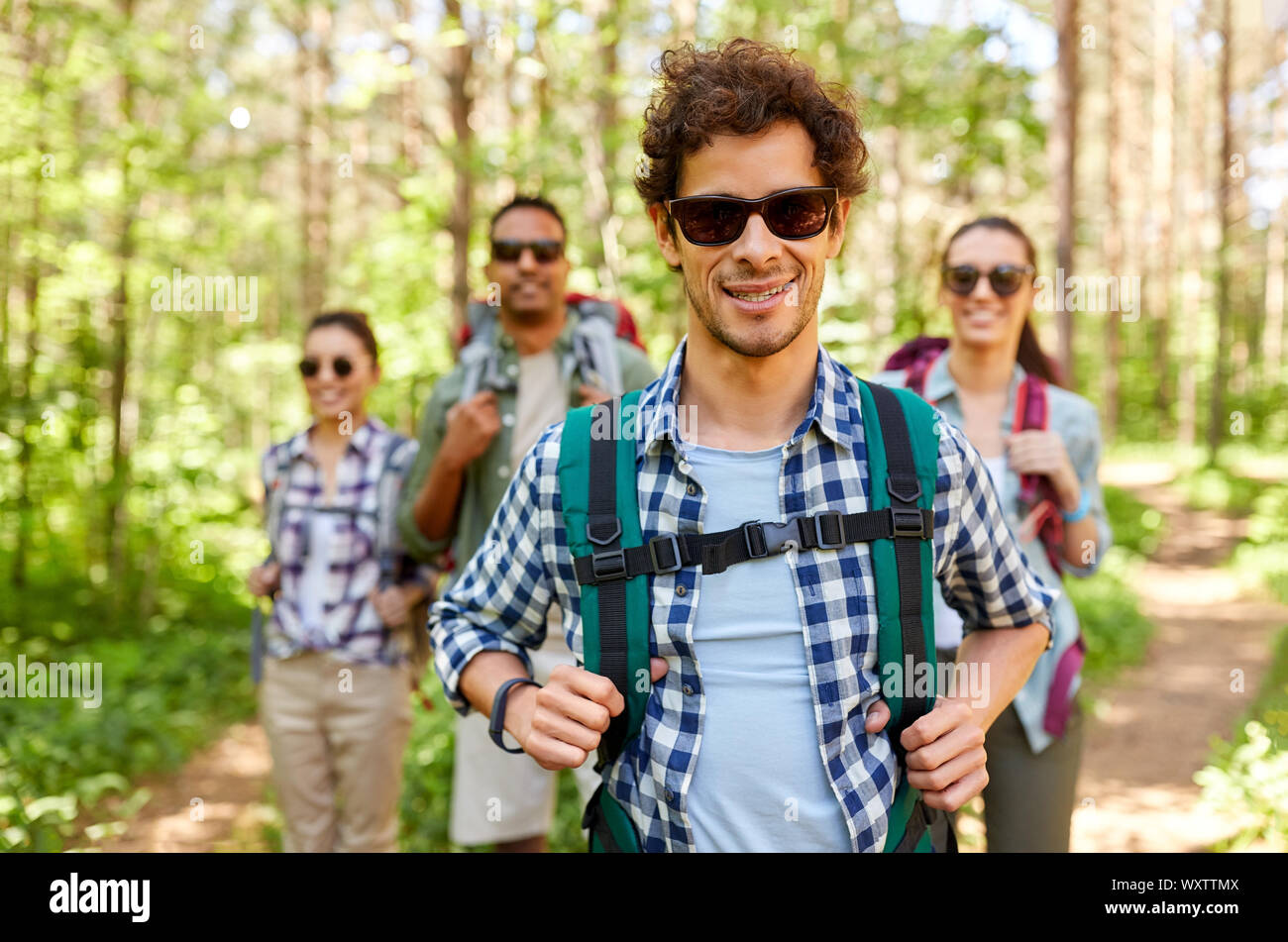 travel, tourism, hike and people concept - group of friends with ...