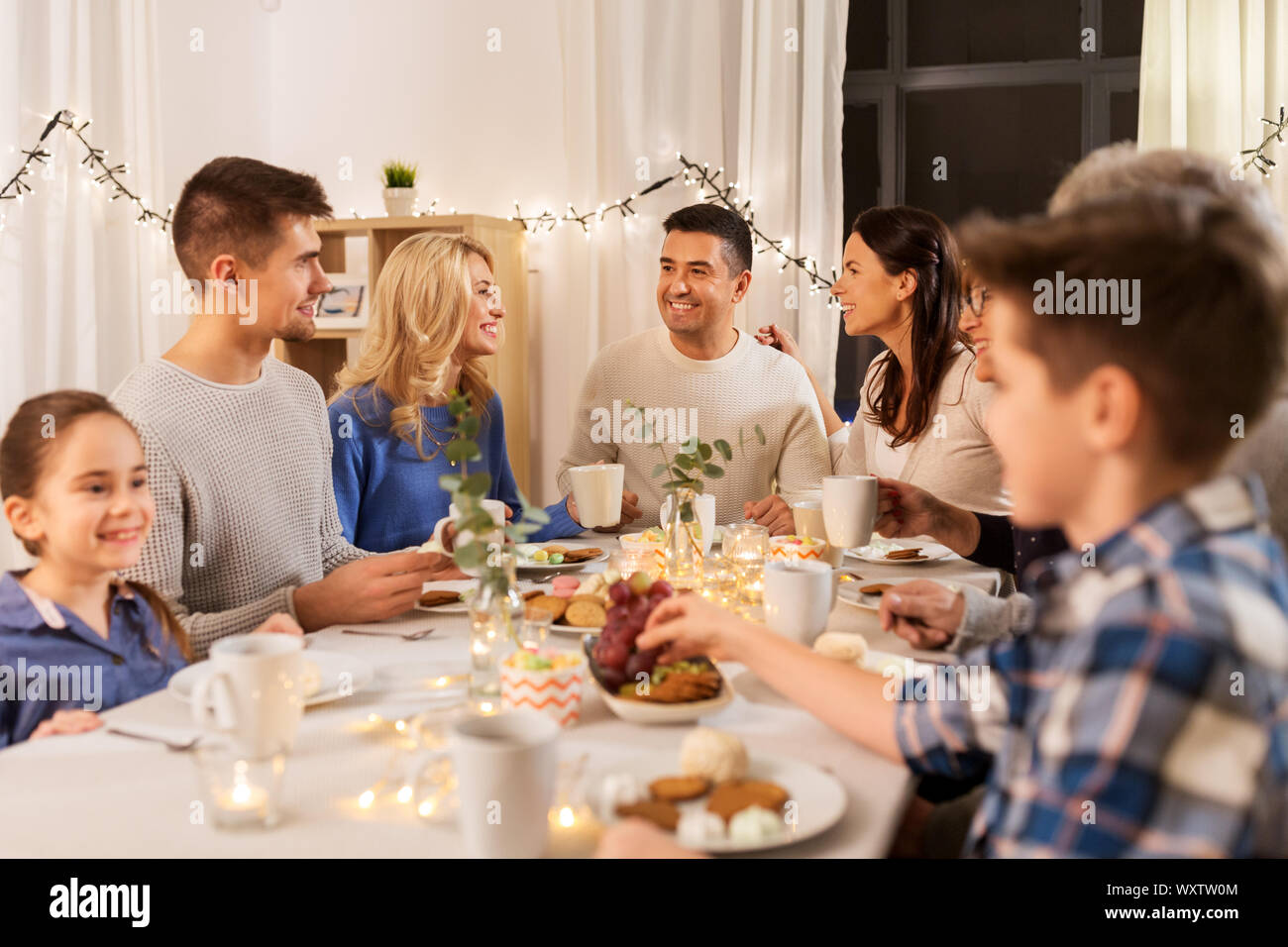 celebration, holidays and people concept - happy family having tea ...