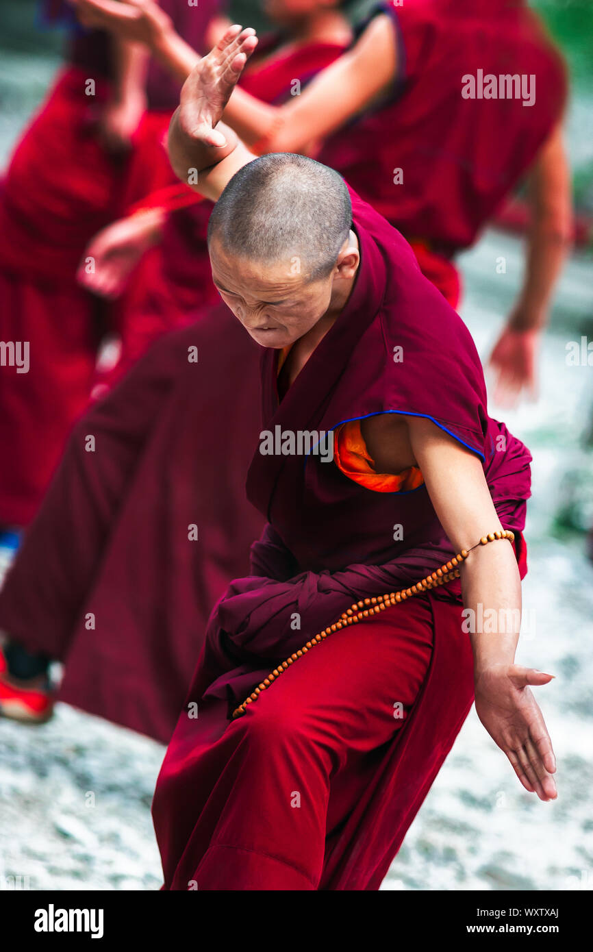 A monk at Sera monastery in Tibet claps his hands as part of a Buddhist ...