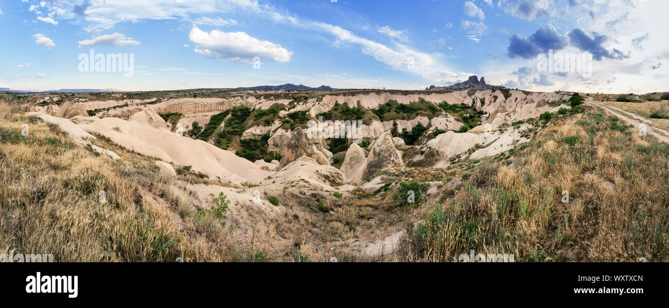 Sandy volcanic cliffs of Cappadocia in the summer. Panorama. Turkey ...