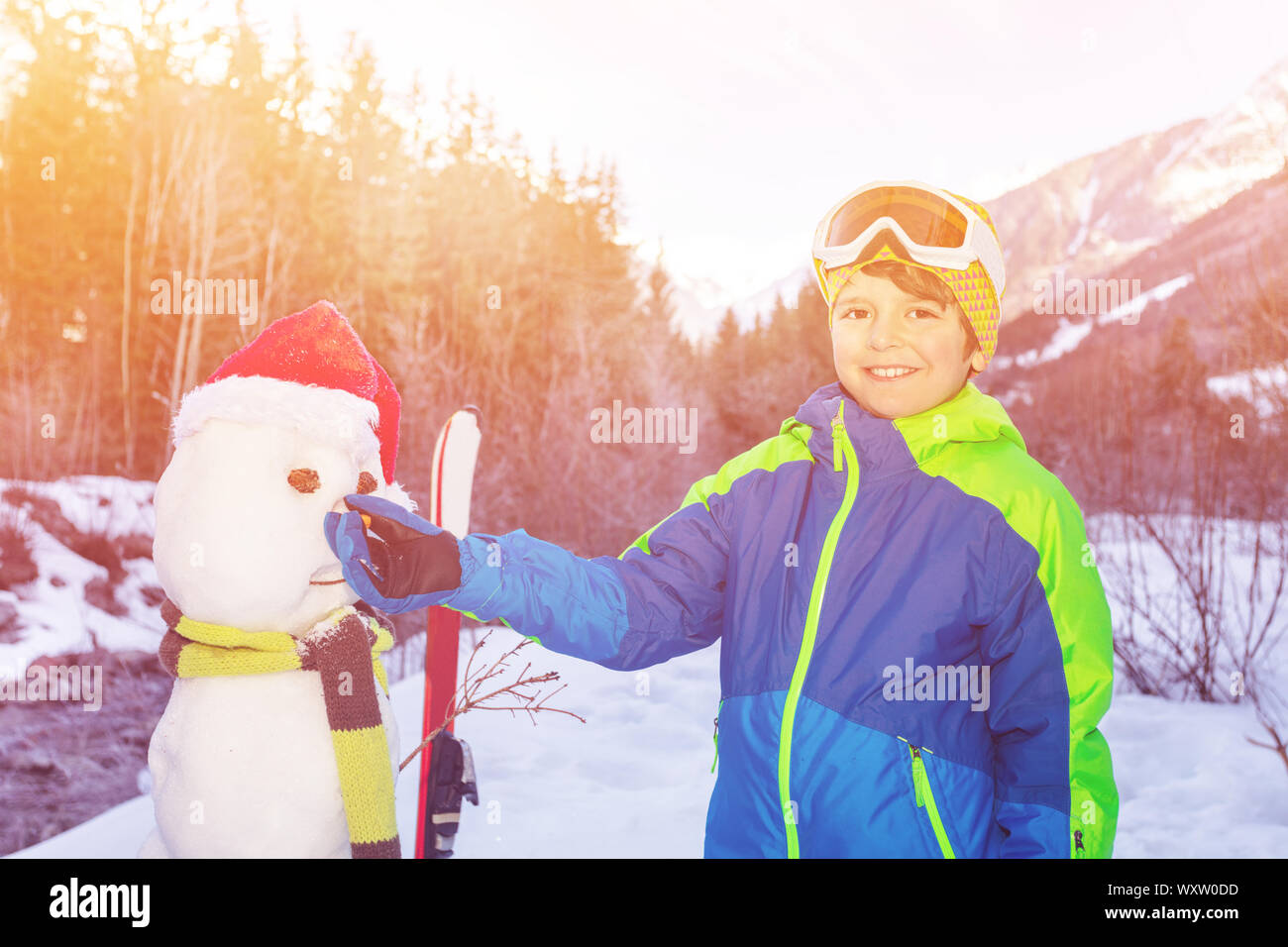 Boy making snowman in hi-res stock photography and images - Alamy