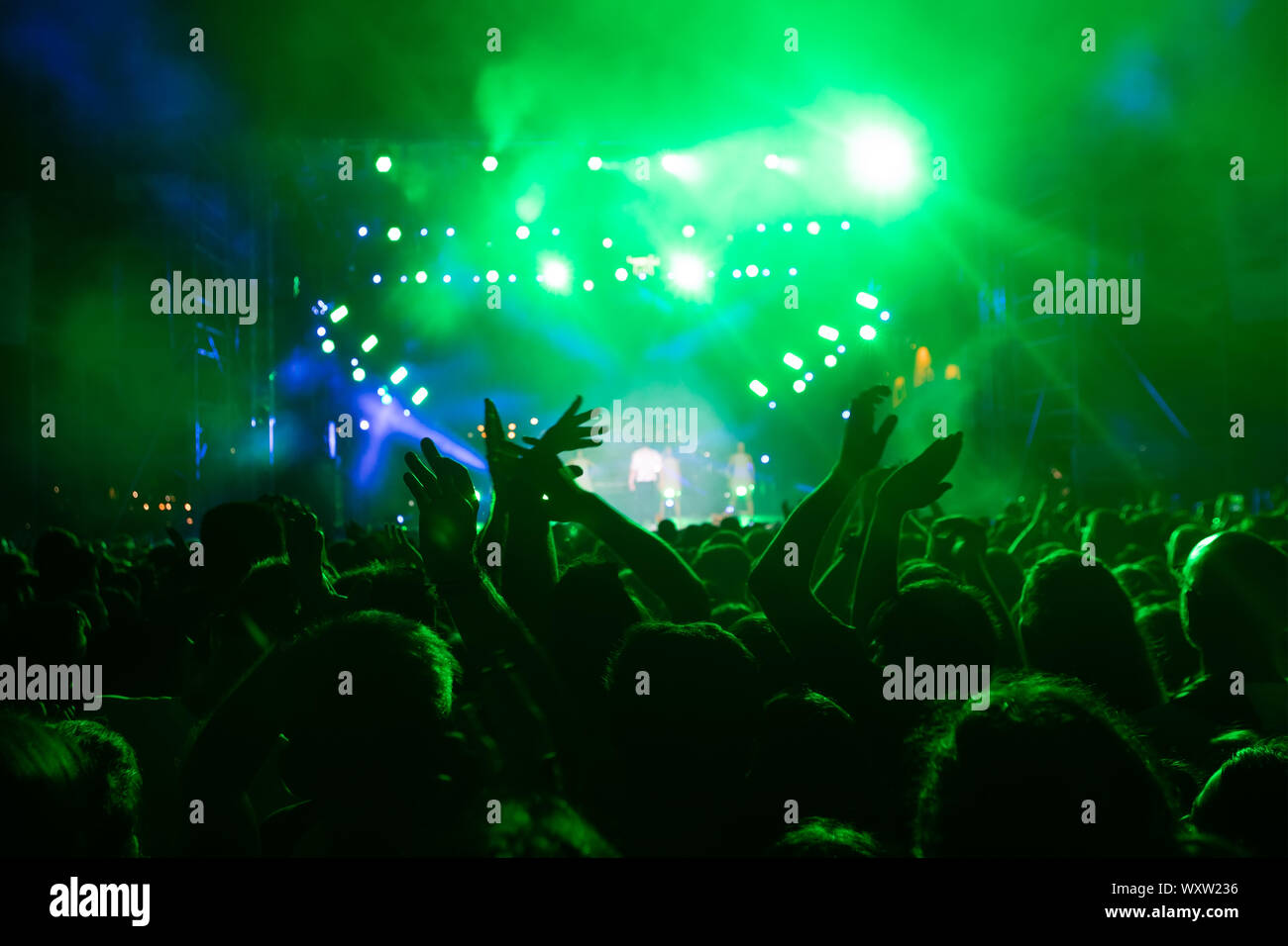 People taking photographs with touch smart phone during a music ...