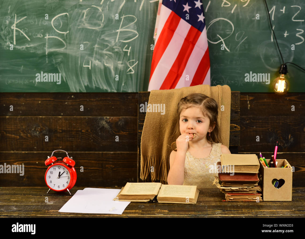Student with books in park against USA flag. English language learning ...