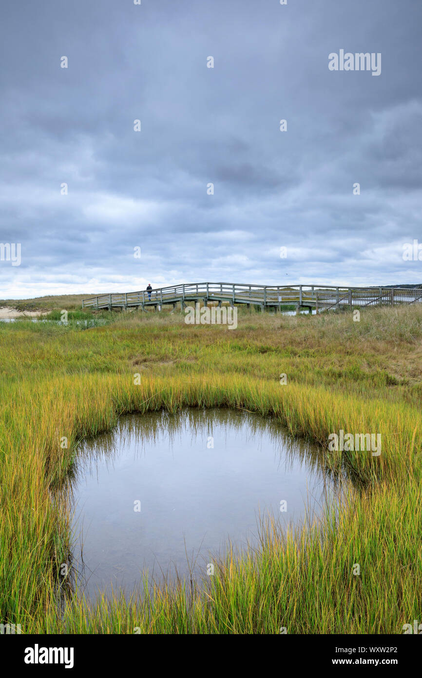 Lone person on wooden footbridge walkway at Ridgevale Beach, Nantucket ...