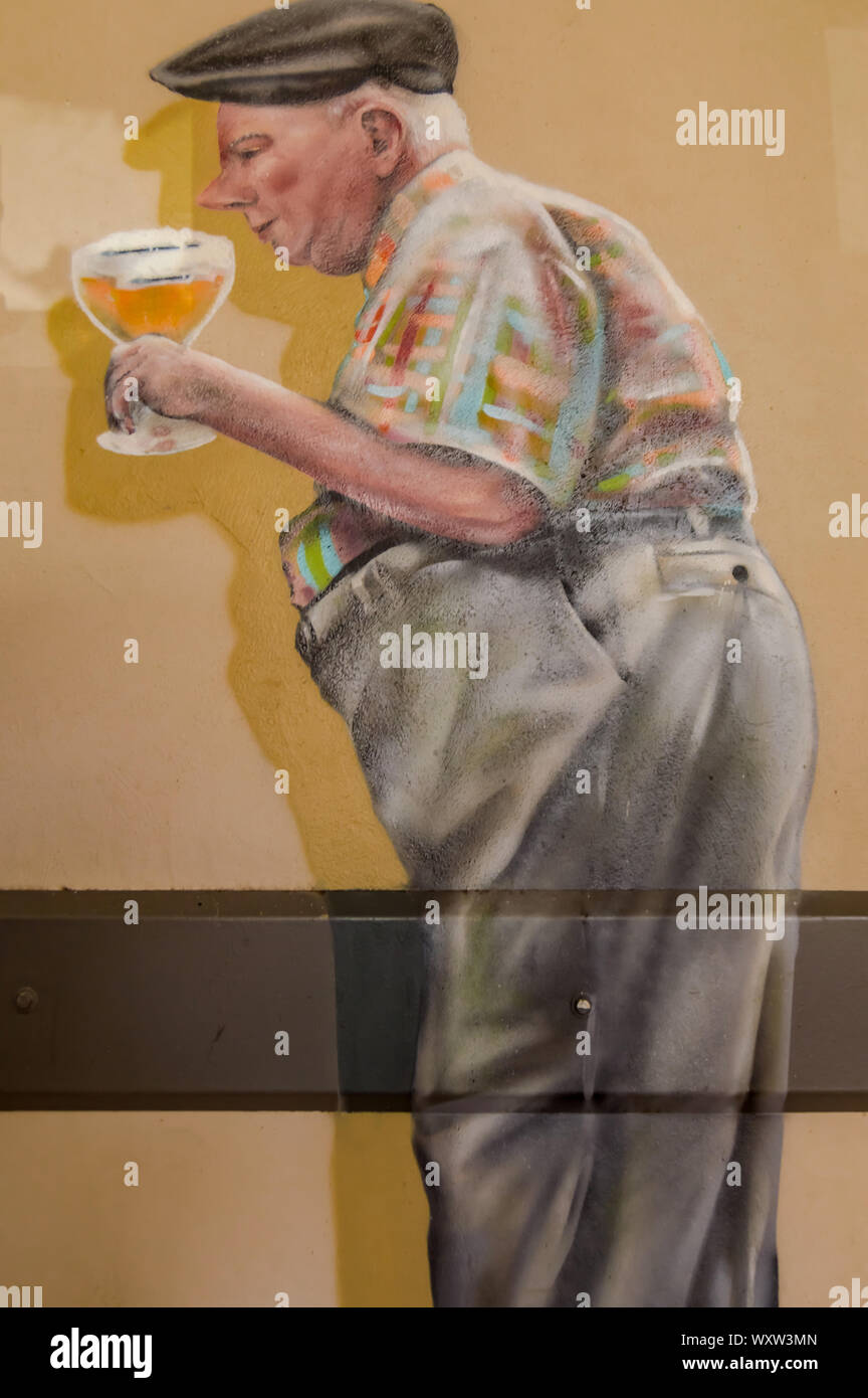 Caricature of a paunchy figure holding a glass of orval in his hand on ...