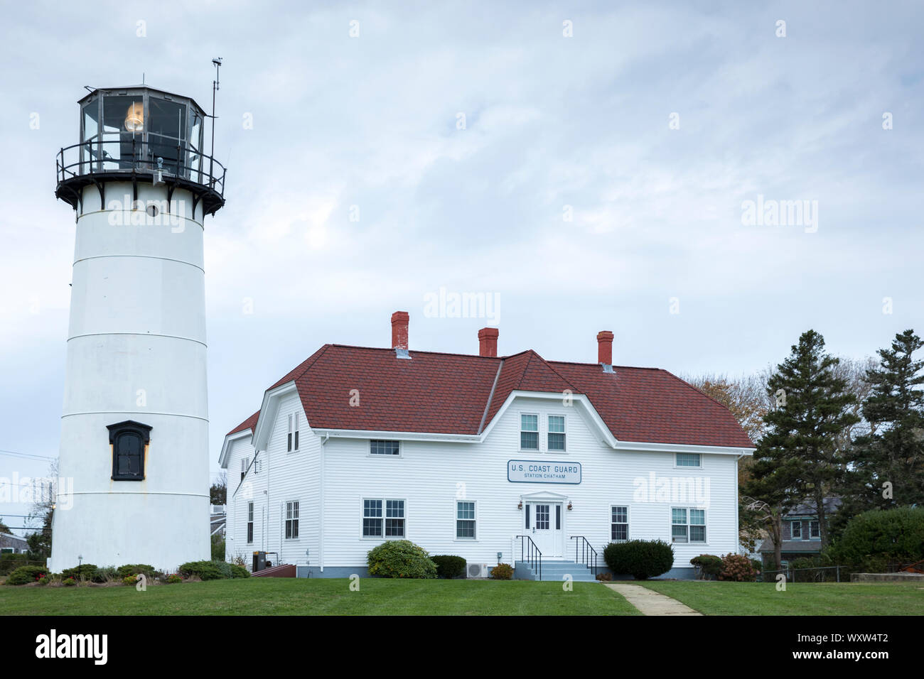 US Coast Guard Station and Lighthouse with lamp beam over the Atlantic ...