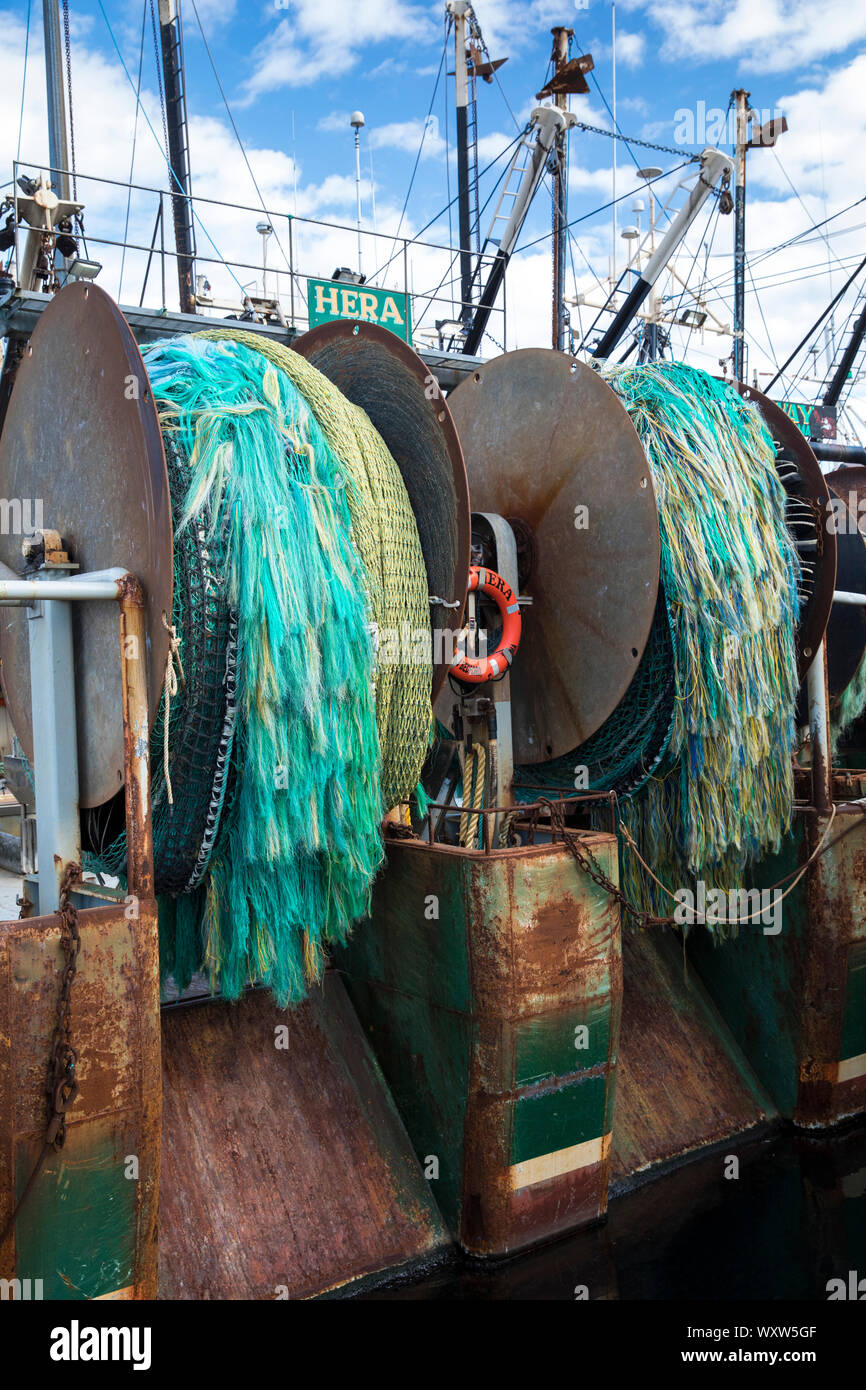 Bright colour plastic rope nets on reel mechanism of fishing boats ...