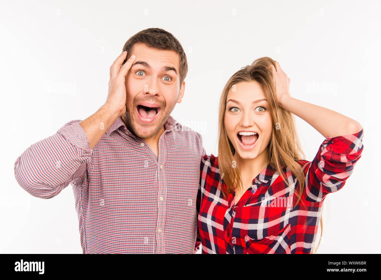 Funny cheerful couple showing surprise Stock Photo - Alamy