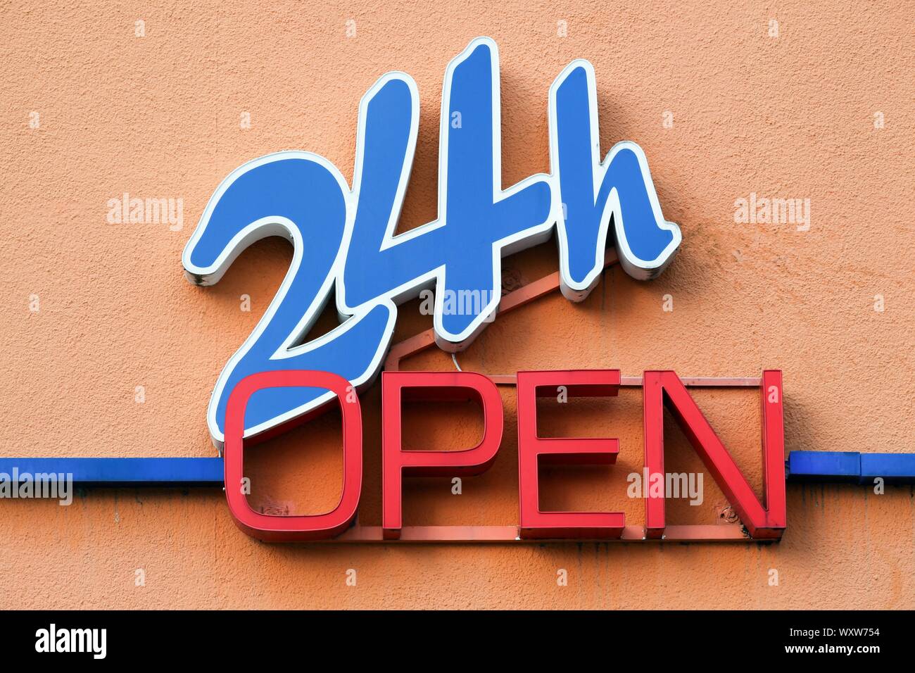 24 hours open sign on a wall Stock Photo - Alamy