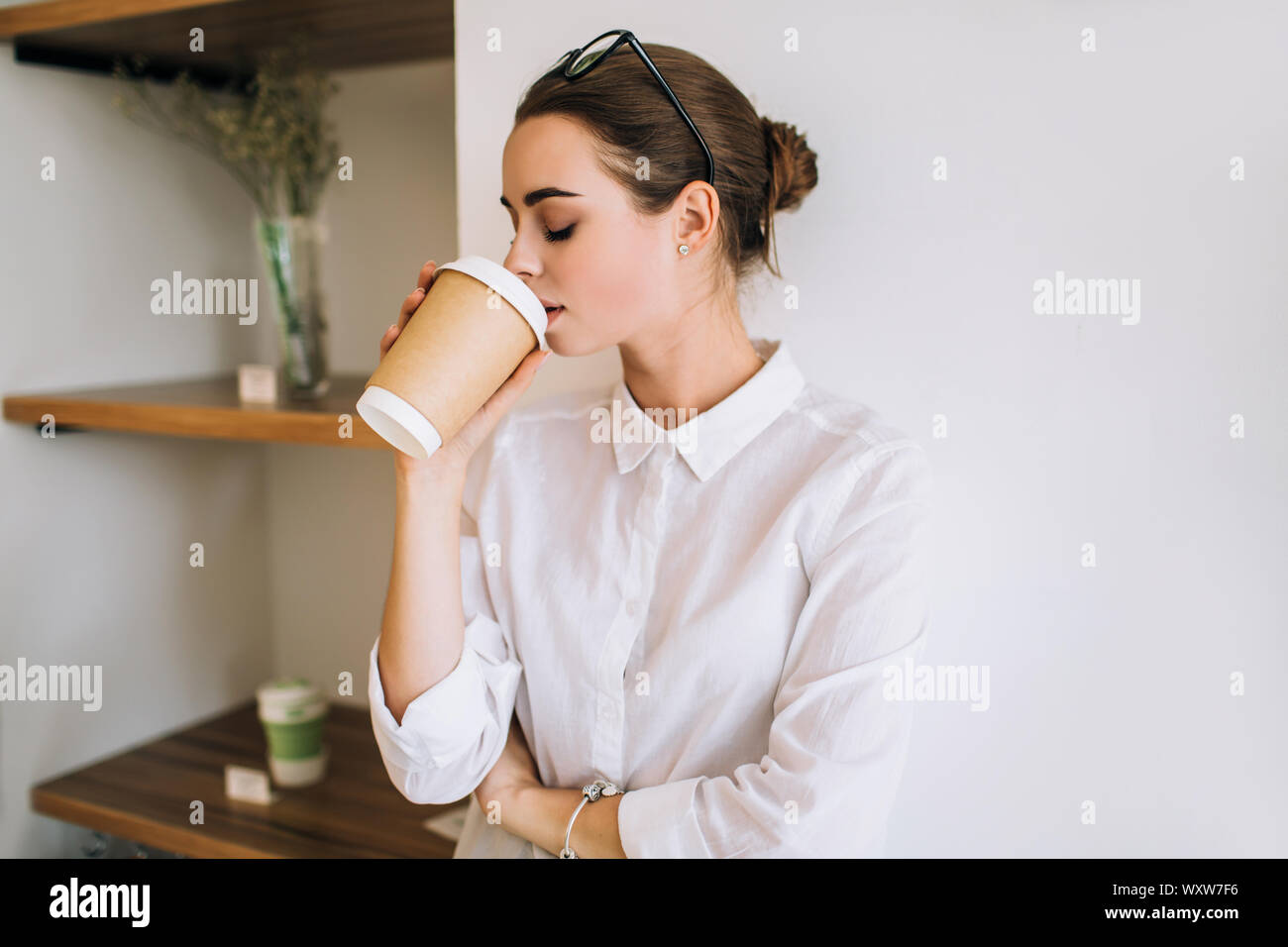 Young attractive girl drinking coffee in the modern stylish cafe ...