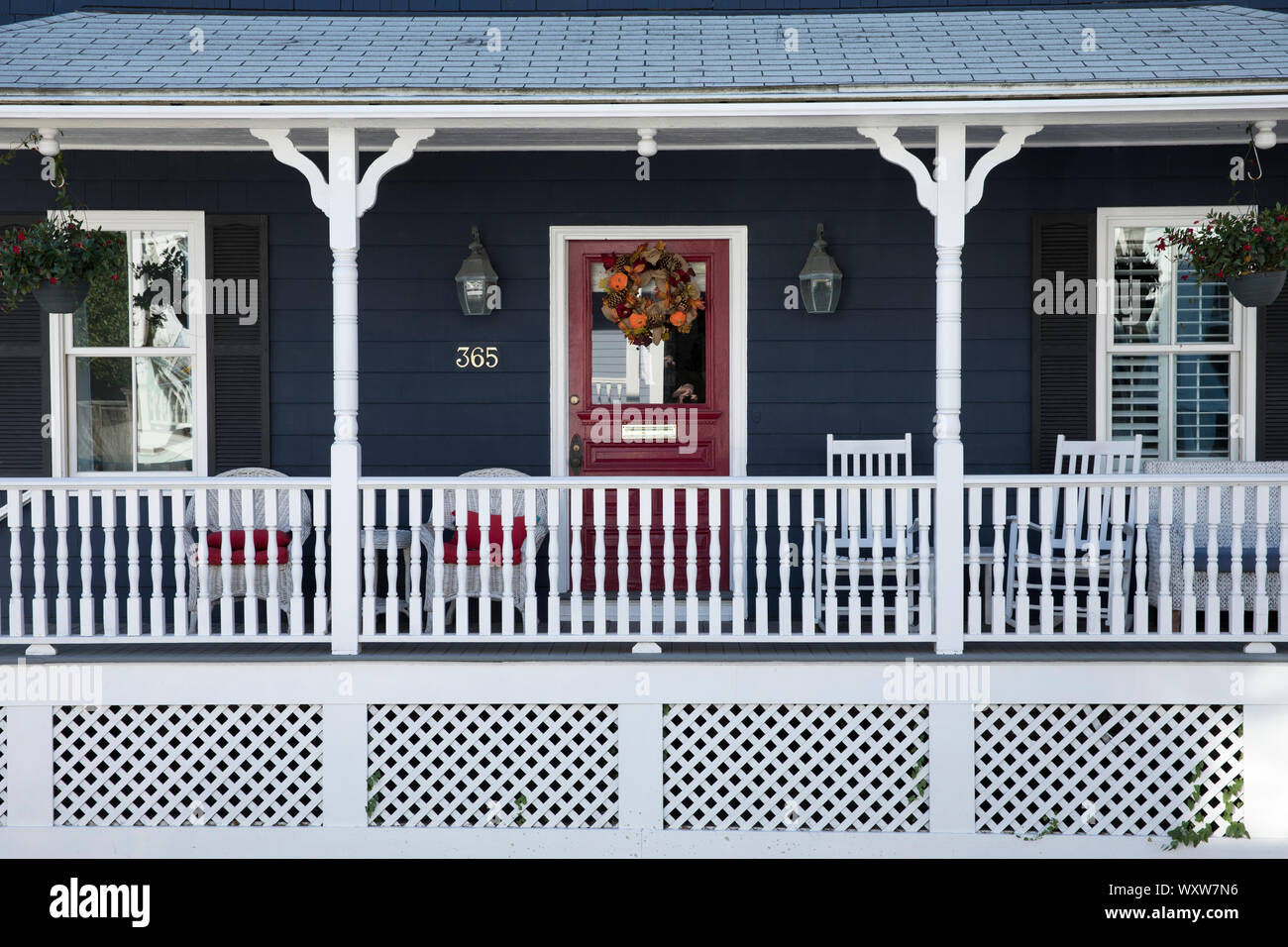 Typical traditional neat painted wooden clapboard house with front ...