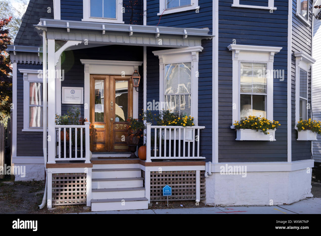 Typical traditional neat painted wooden clapboard house with front ...
