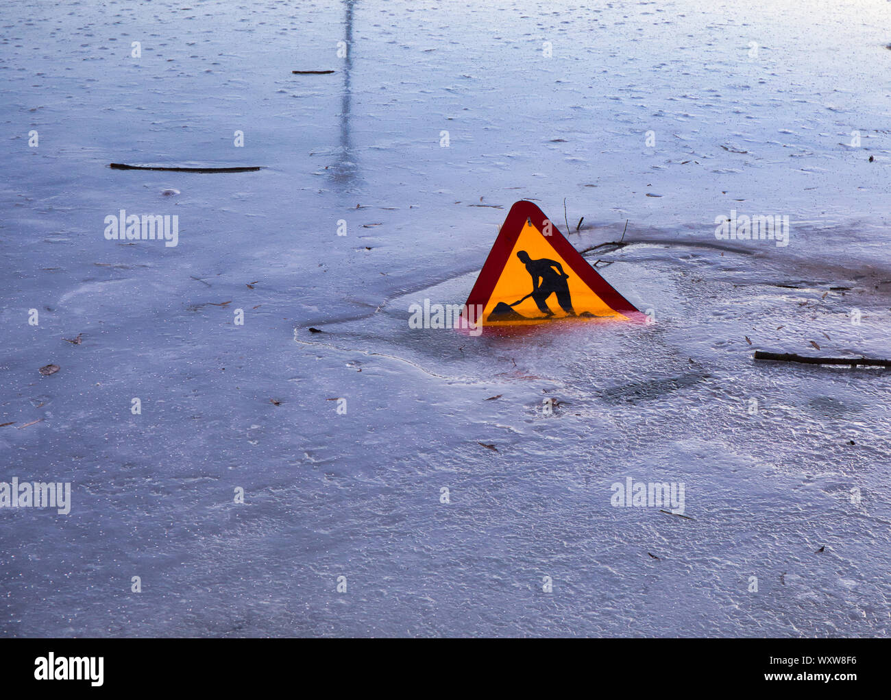 Men digging road sign trapped in ice, Stockholm, Sweden, Scandinavia ...