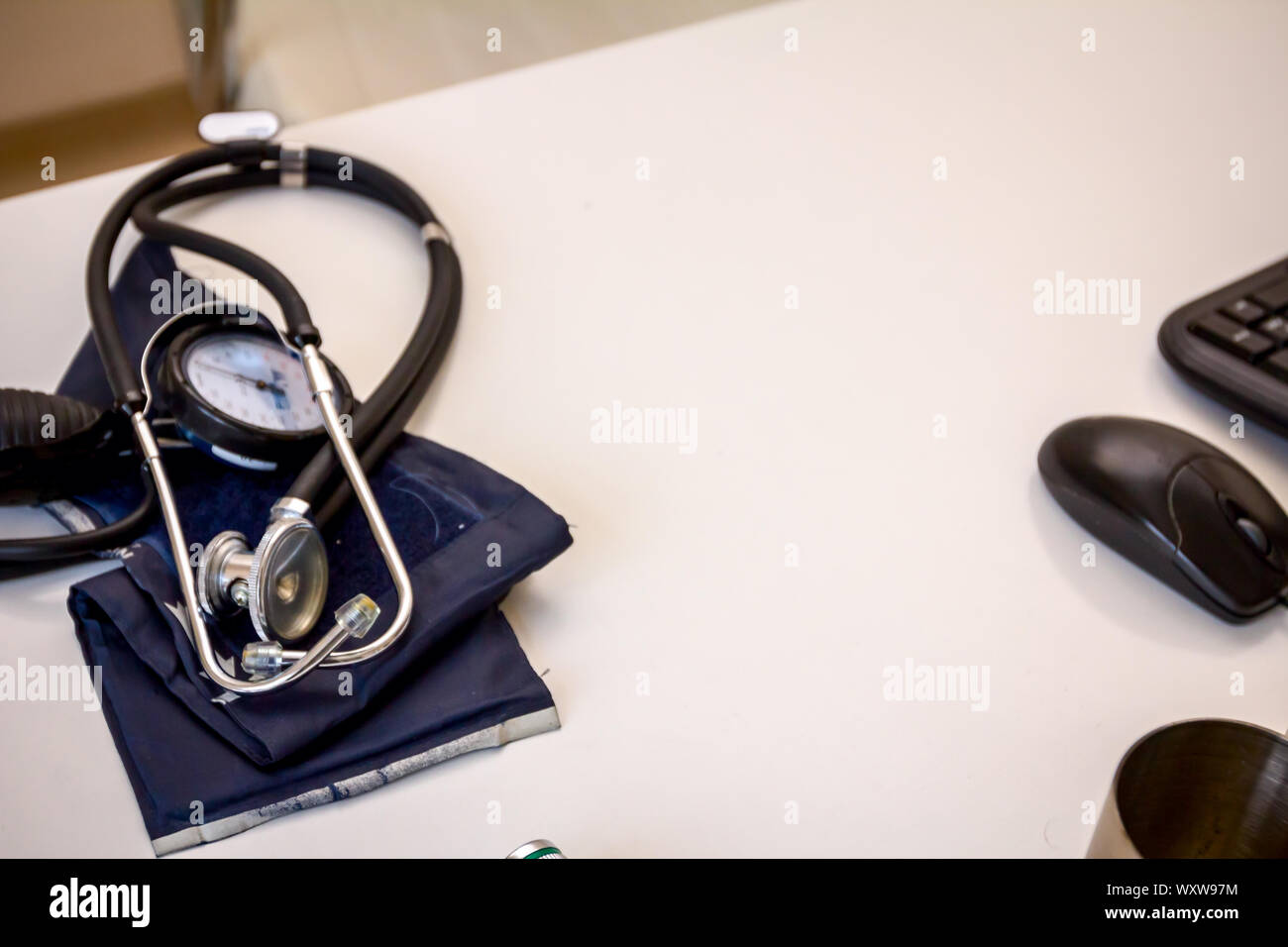Doctor's table with medical equipment for examining the blood pressure ...