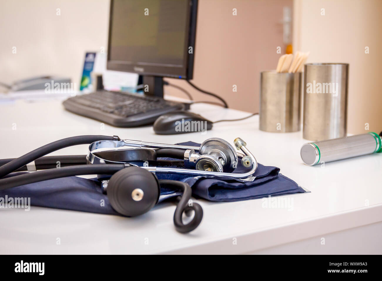 Doctor's table with medical equipment for examining the blood pressure ...