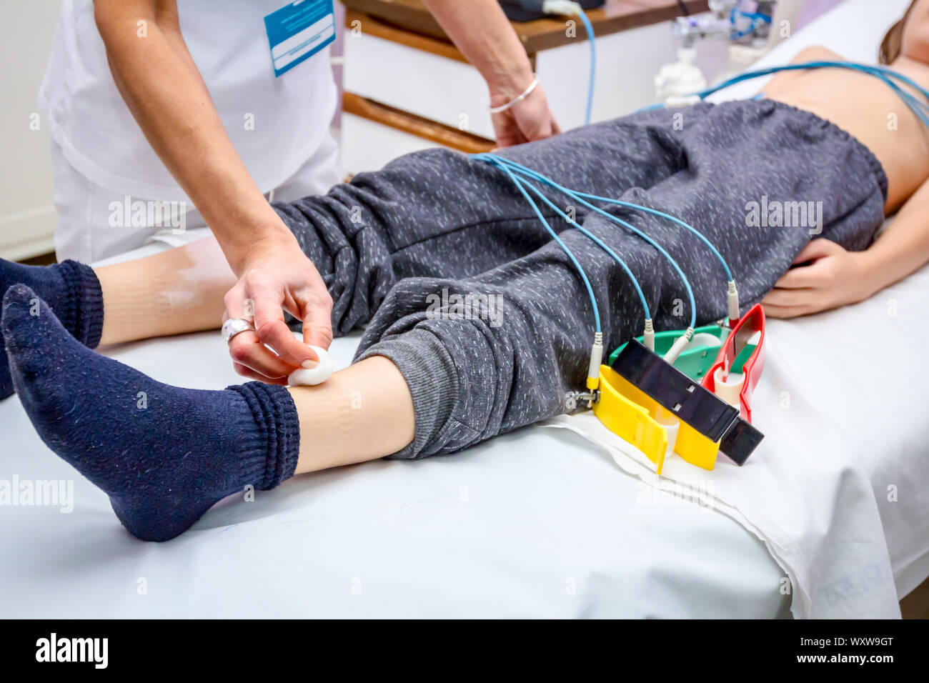 Cardiologist is attaching vacuum sensors to child, teenager patient for ...