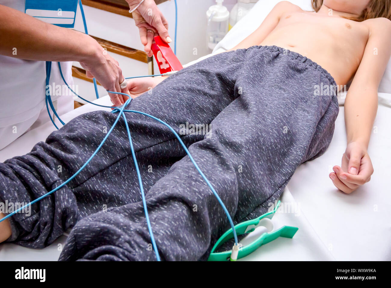 Cardiologist is attaching vacuum sensors to child, teenager patient for ...