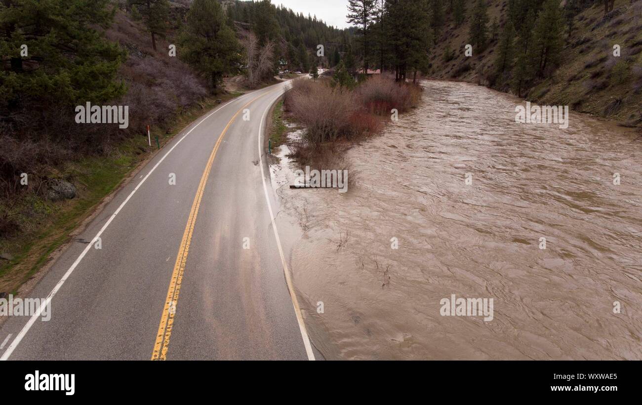 flooded river spreading into the streets as shot from a drone Stock ...