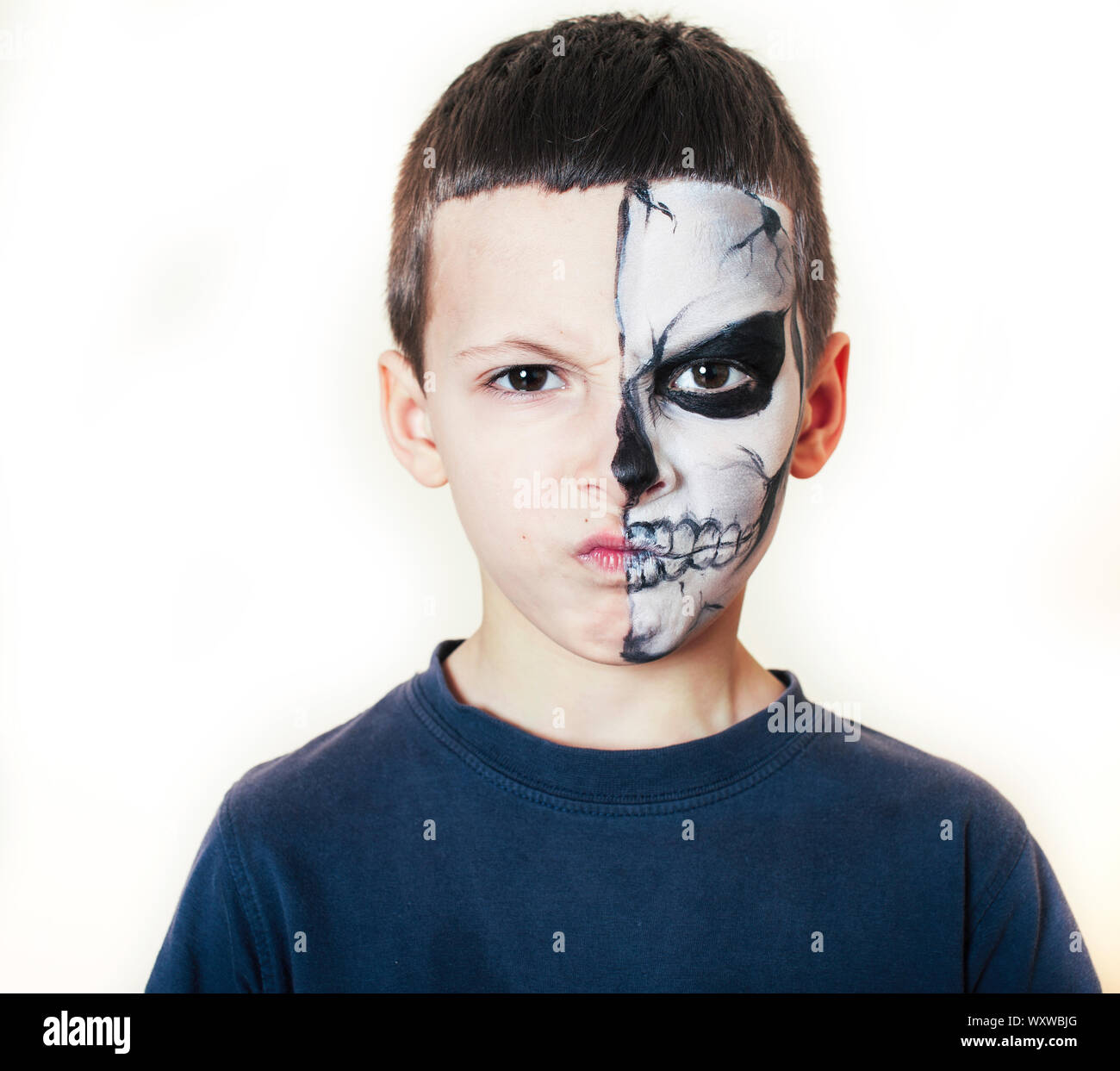 little cute boy with face paint like skeleton to celebrate halloween ...