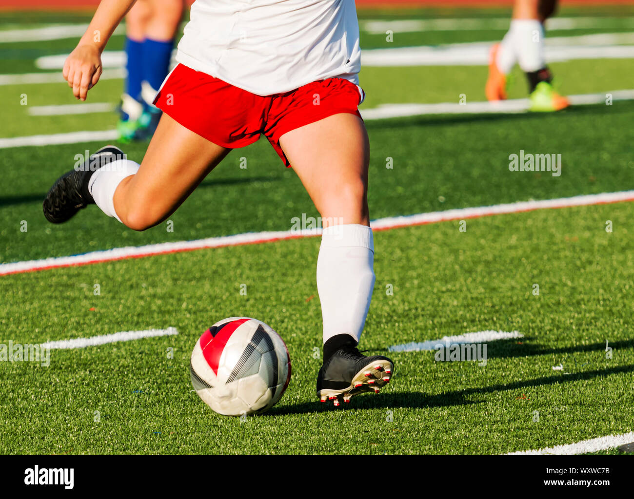 Girl kicking ball hi-res stock photography and images - Alamy
