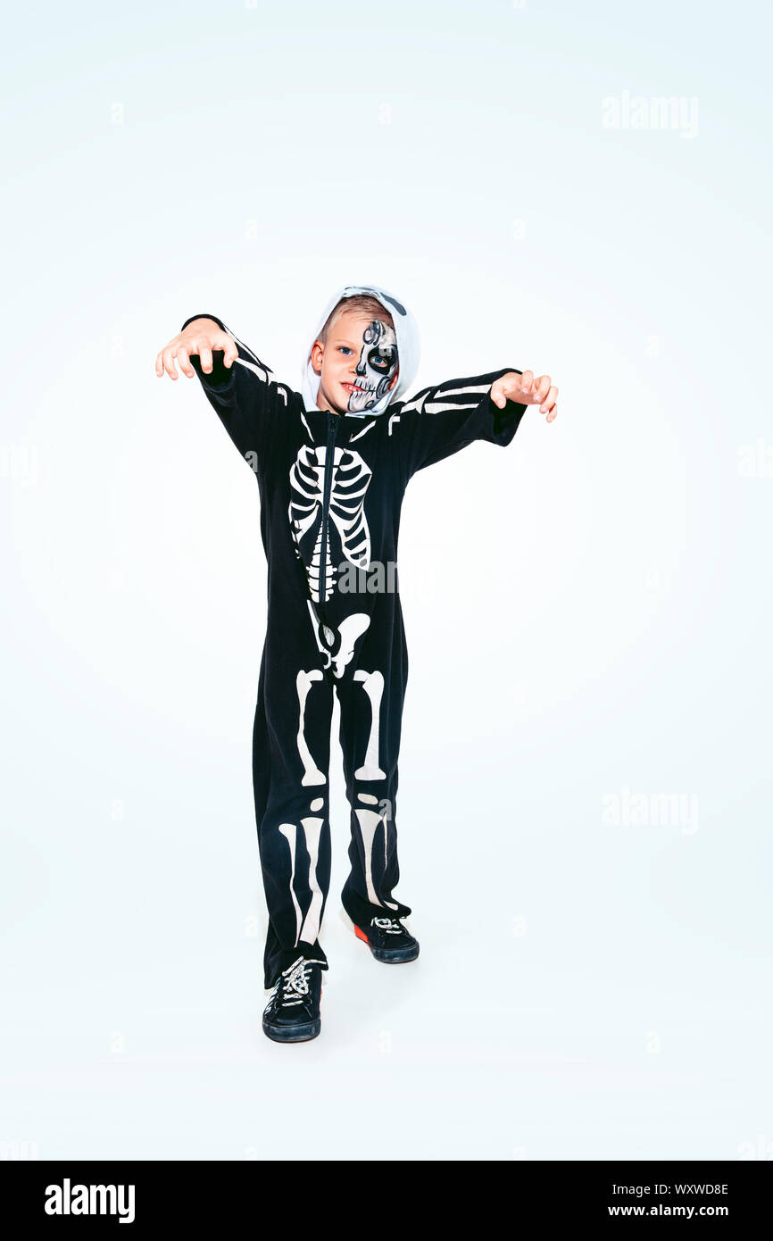 Little boy like a vampire in scary black costume with bones on white ...