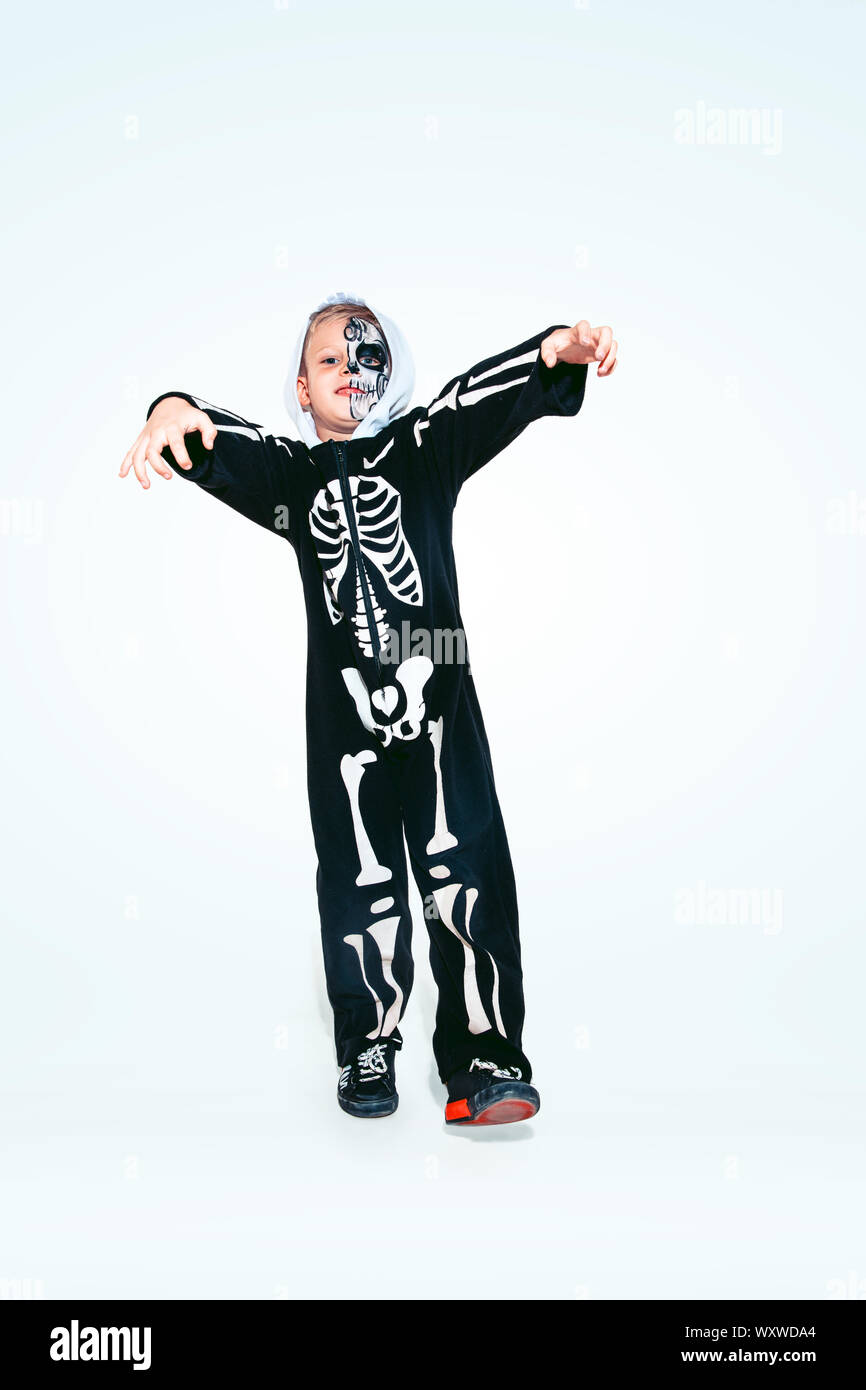 Little boy like a vampire in scary black costume with bones on white ...