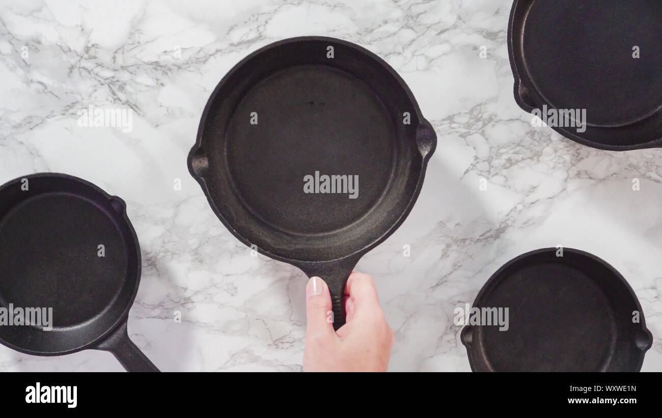 Flat lay. Variety of cast iron kitchenware on a marble countertop Stock ...