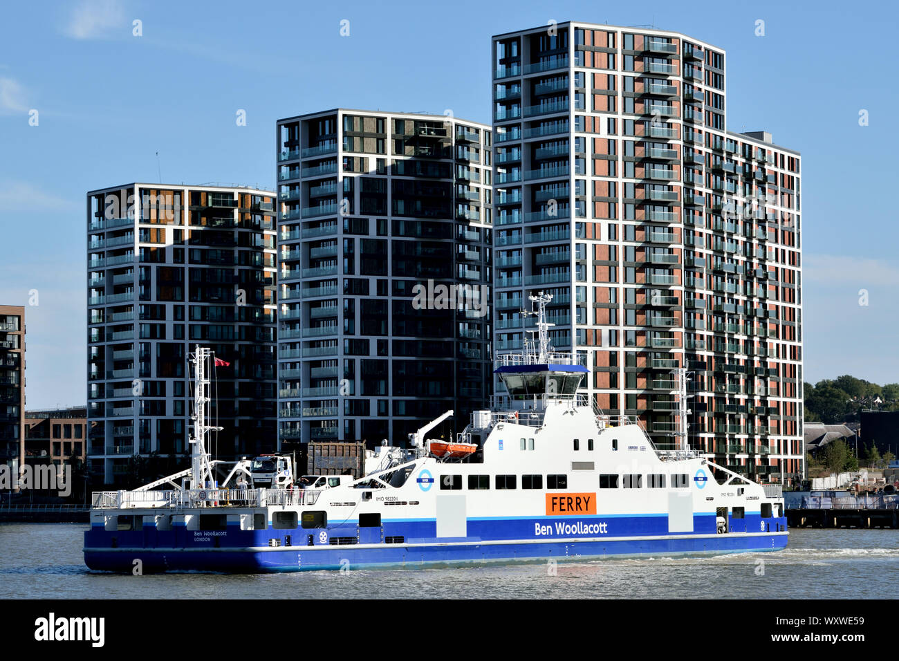 Woolwich Ferry vessel seen passing one of the new apartment blocks in ...