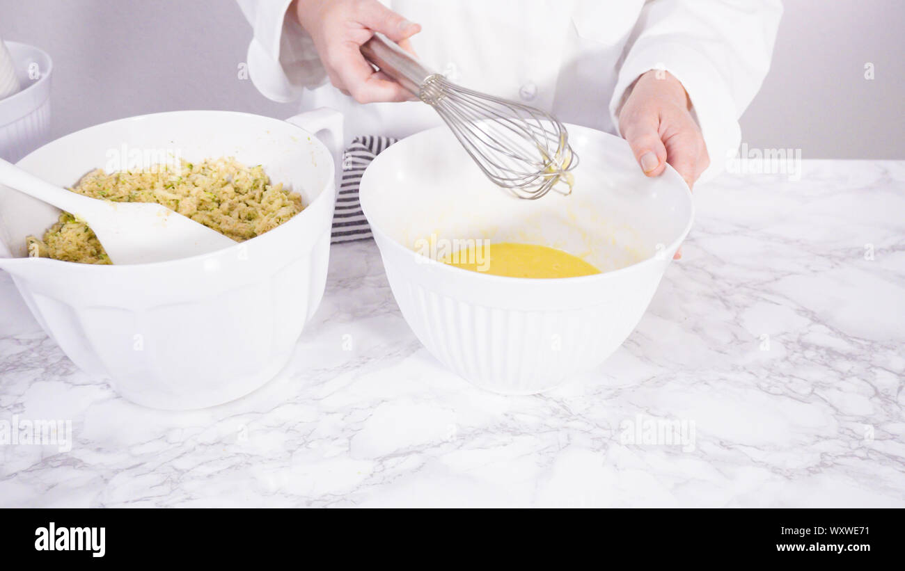 Step by step. Mixing ingredients in a mixing bowl to make zucchini ...