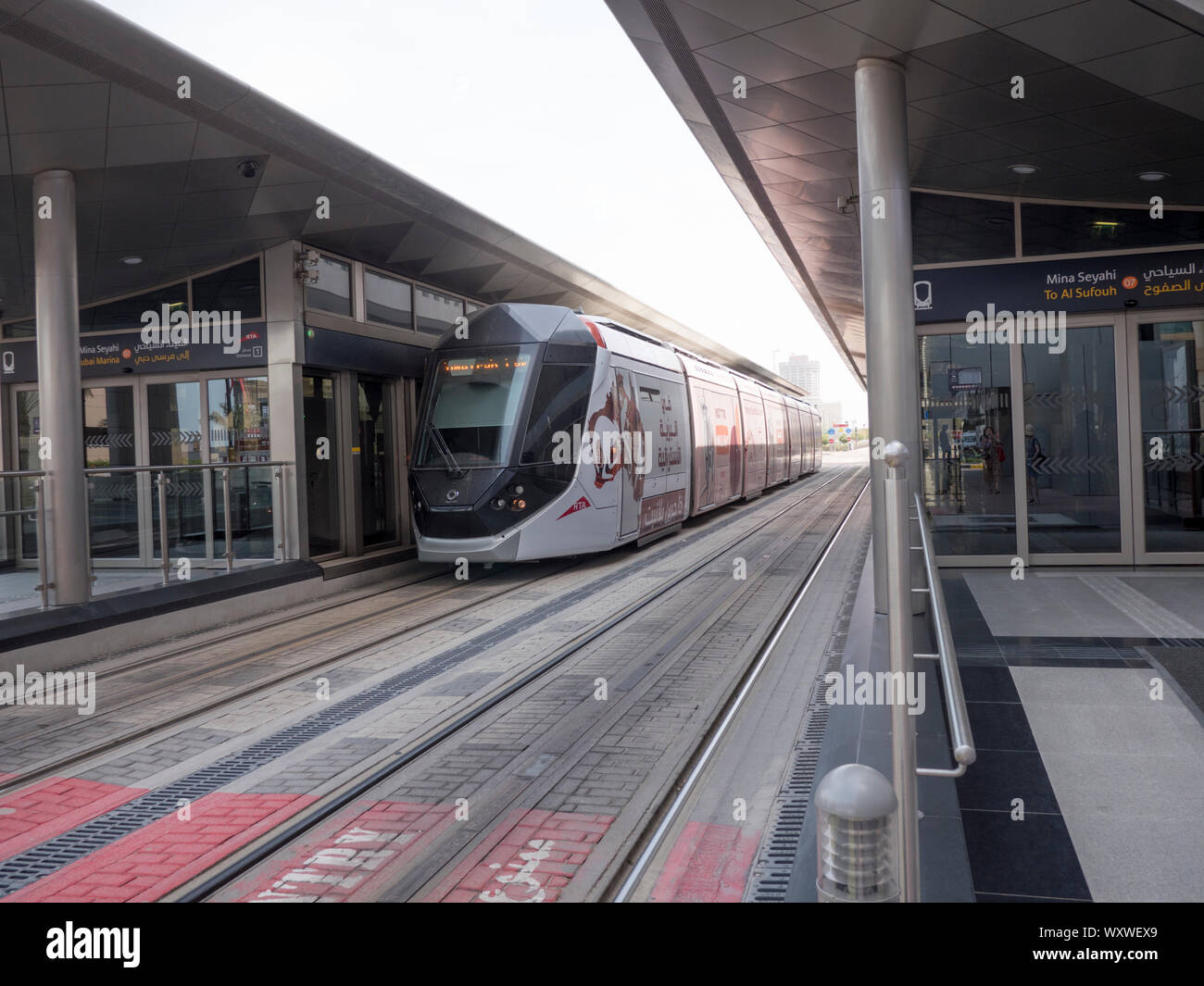 Tram at tram station stop on Dubai tramway Stock Photo - Alamy