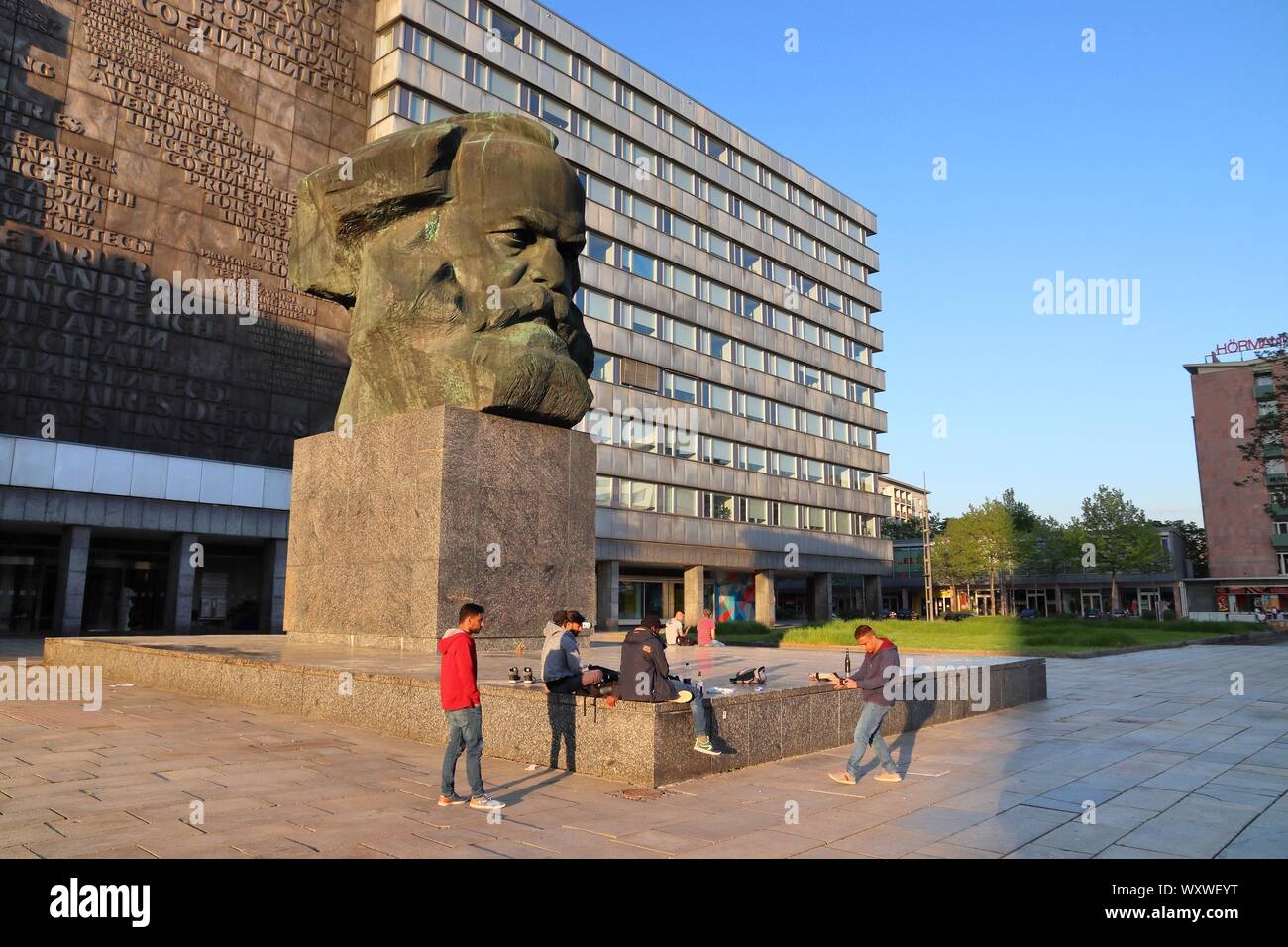 CHEMNITZ, GERMANY - MAY 8, 2018: People sit by huge Karl Marx monument ...