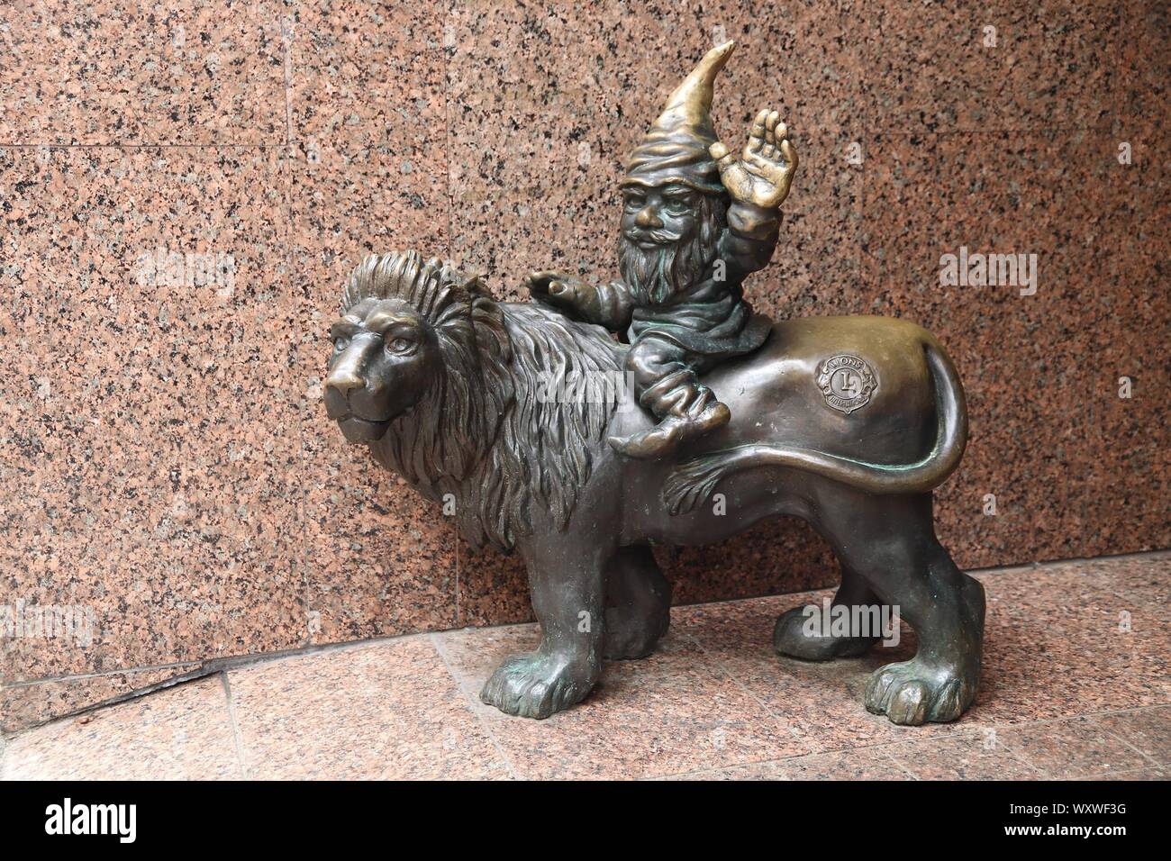 WROCLAW, POLAND - MAY 11, 2018: Lion riding gnome or dwarf small statue ... WROCLAW, POLAND - MAY 11, 2018: Lion riding gnome or dwarf small statue ...